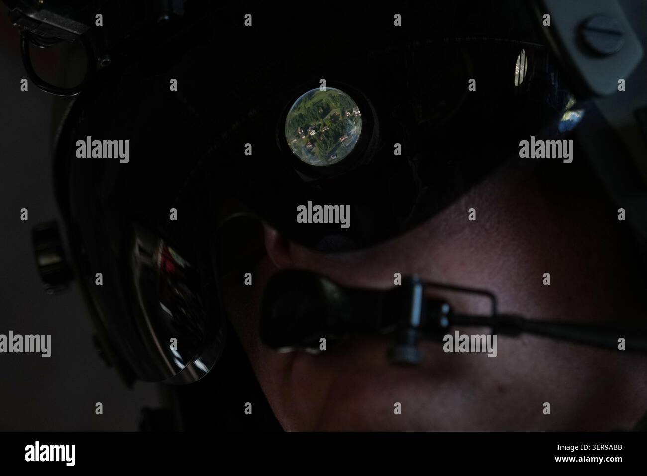 A reflection is seen in helicopter crew-member's googles during ...