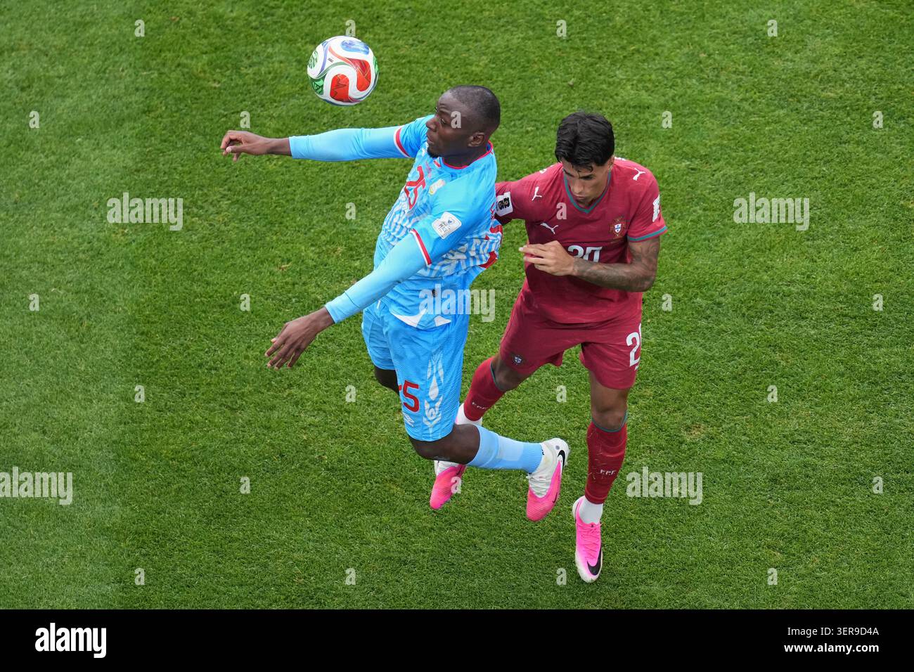 Congo's Edo Kayembe (25) and Portugal's Joao Cancelo (20) jump for the ...