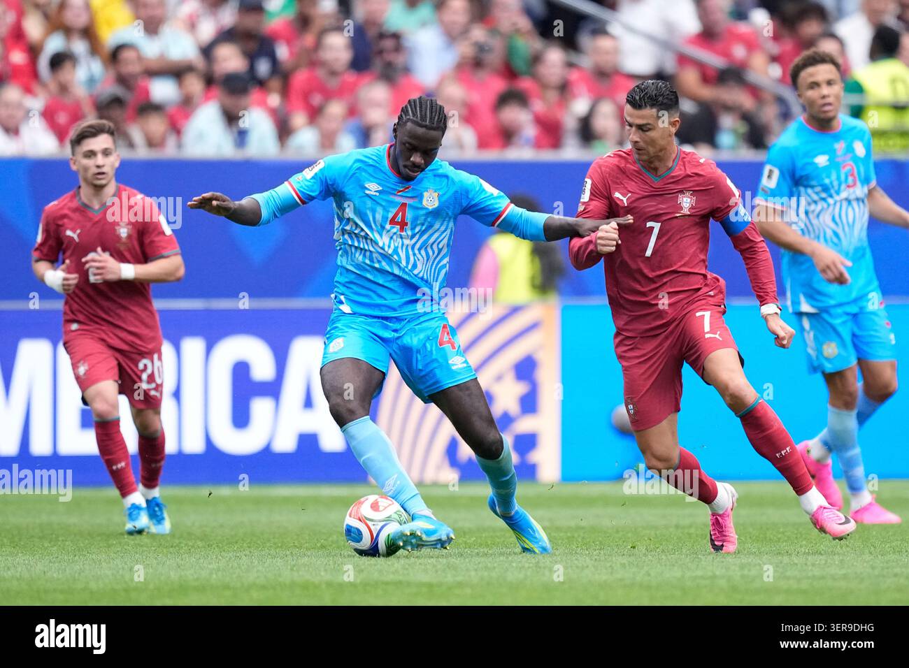Congo's Axel Tuanzebe shields the ball from Portugal's Cristiano ...