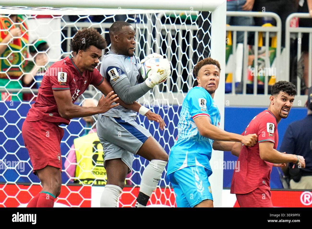 Congo goalkeeper Lionel Mpasi, second left, saves the ball next to ...