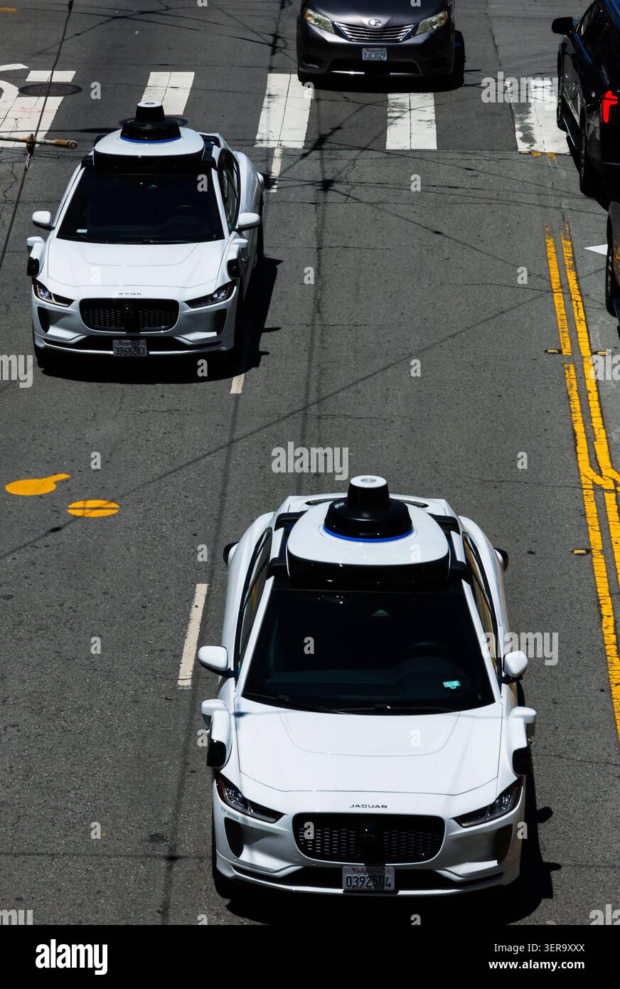 Waymo vehicles travel on Stockton St. in Chinatown in San Francisco on ...
