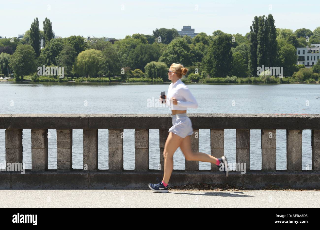 Eine Frau joggt bei Temperaturen um die 25 Grad über die ...