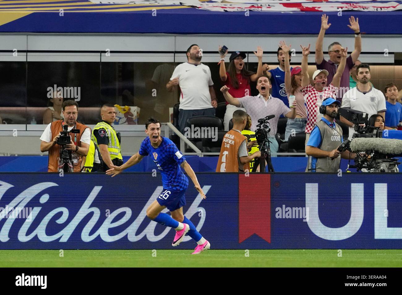 Fans cheer as Croatia's Petar Musa (26) celebrates scoring his team's ...