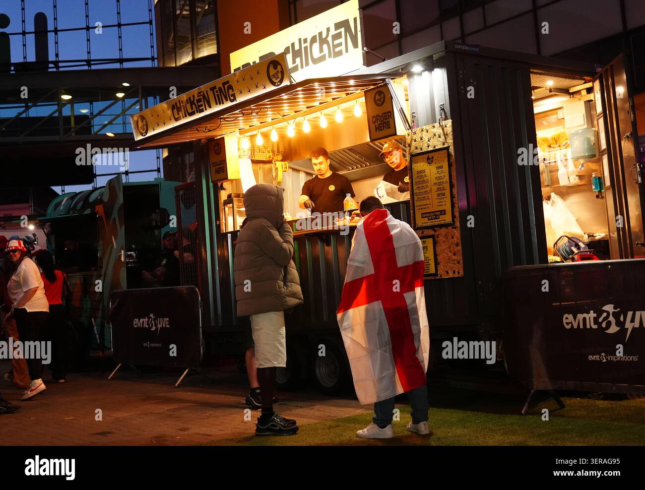 Fans get fast food as they watch a screening of the FIFA World Cup ...