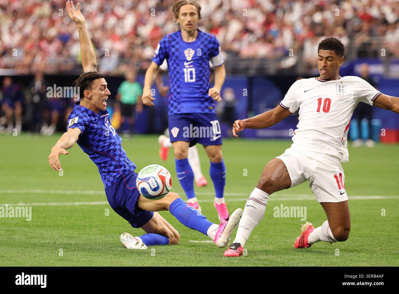 Croatia's Petar Musa is blocked by England's Jude Bellingham during the ...