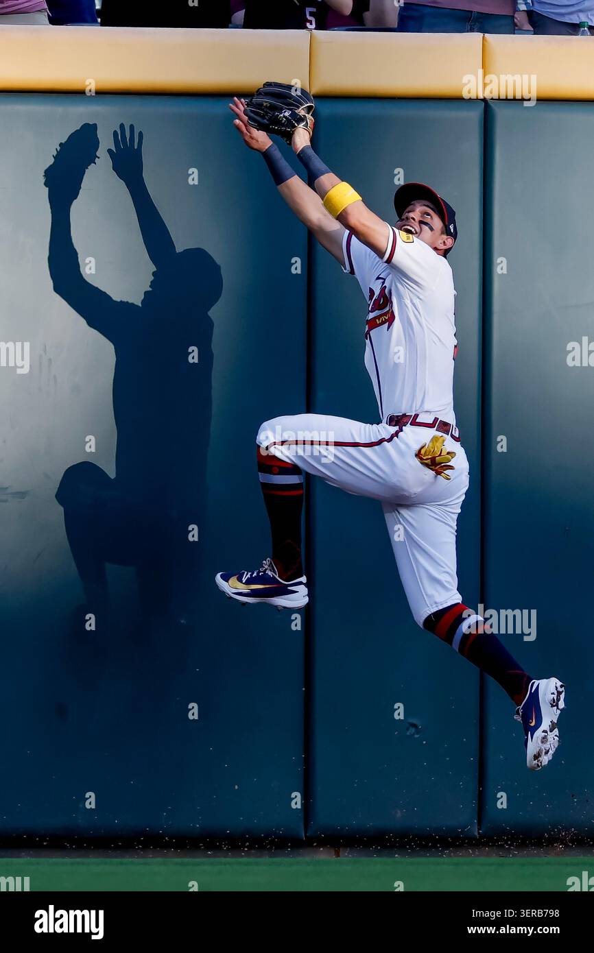 Atlanta Braves center fielder Mauricio Dubon tries to a catch a home ...