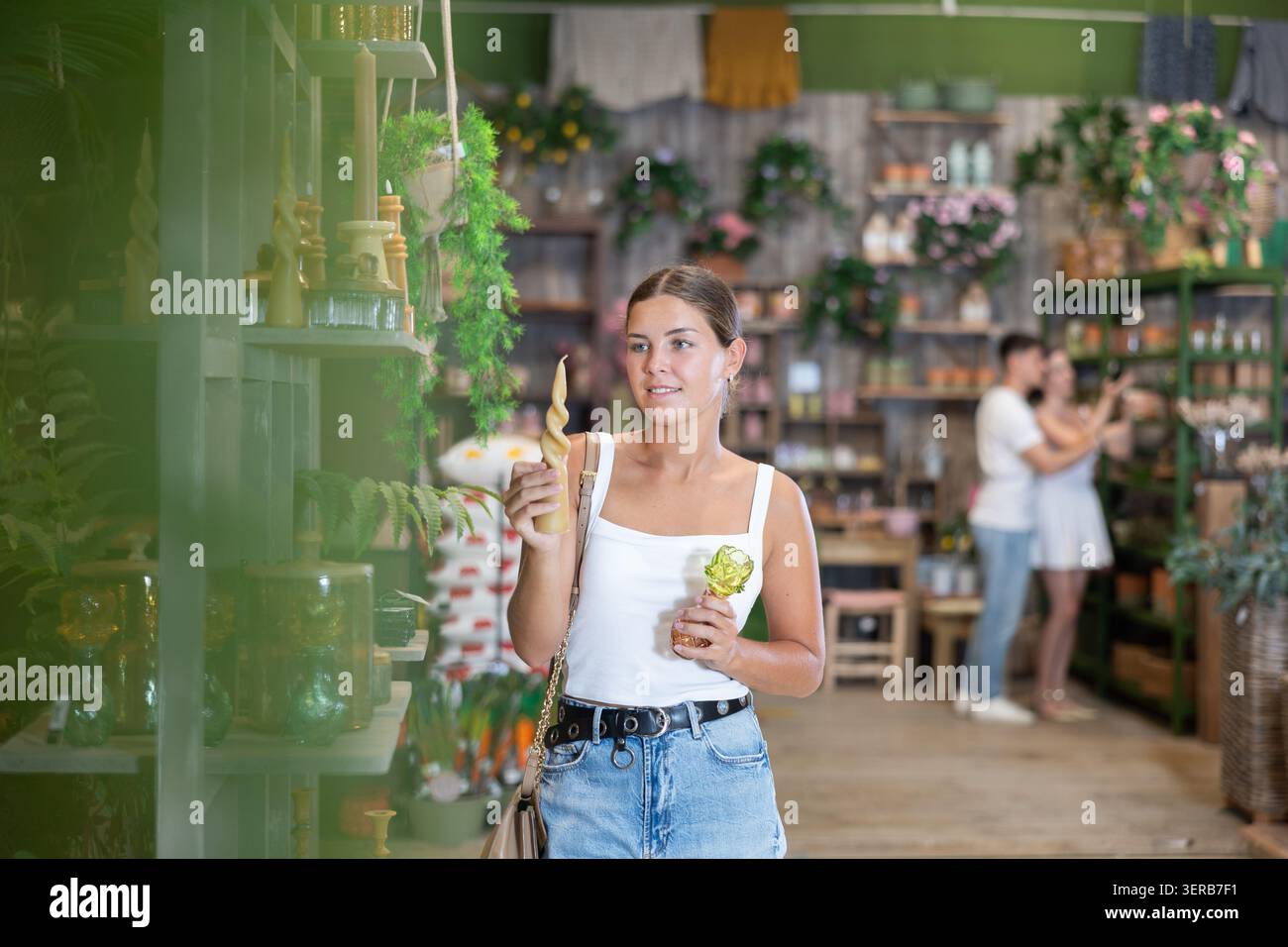 Young girl choosing gift in cosy home decor store Stock Photo - Alamy