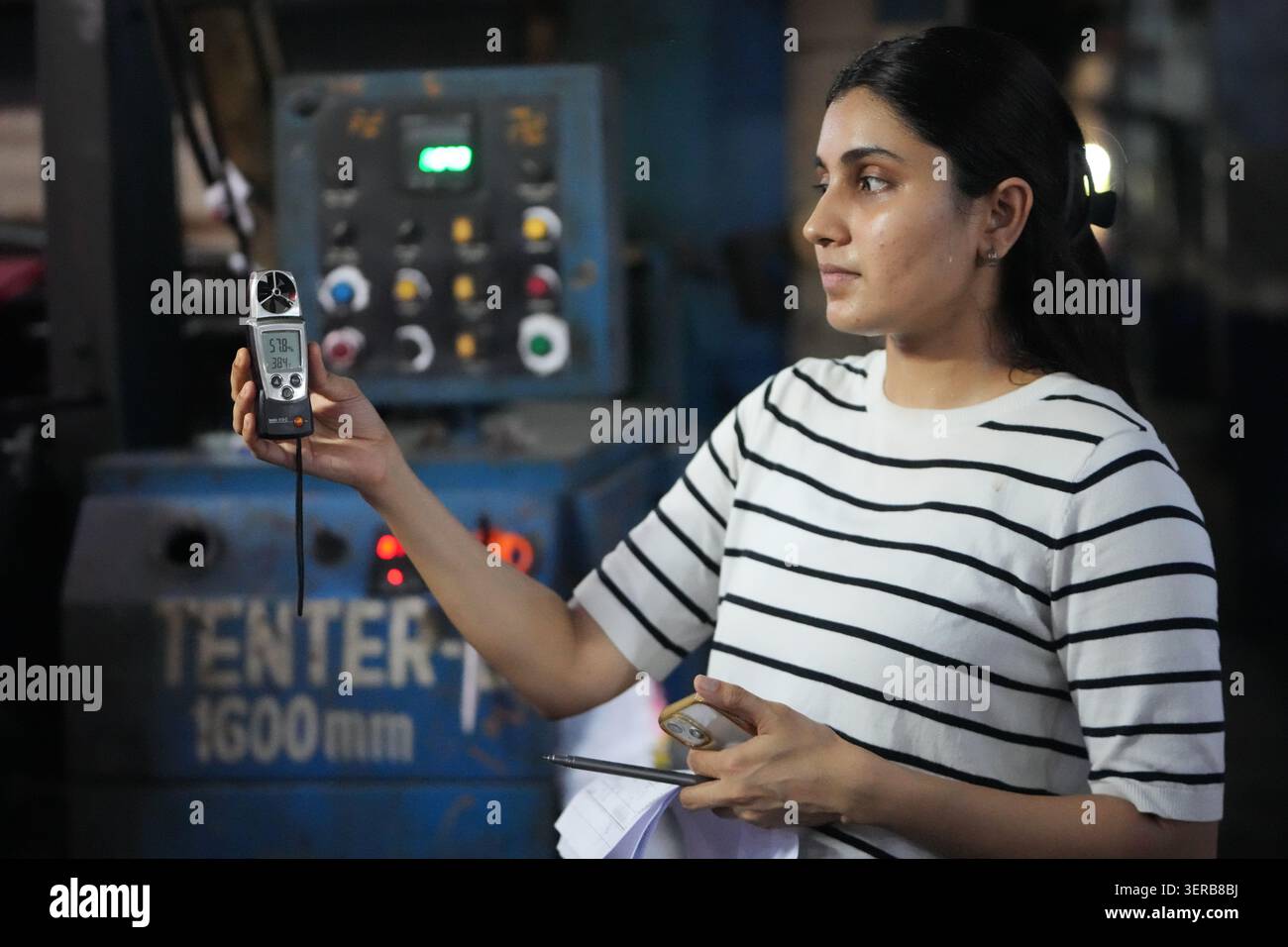 Pooja Yadav, of the think tank WRI India, shows temperature and ...