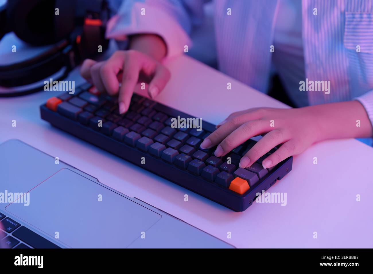 Cropped hands typing on mechanical gaming keyboard for digital ...
