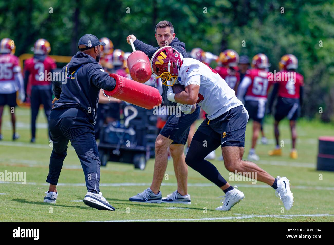 Washington Commanders tight end Quentin Moore (40) runs thru coaches ...
