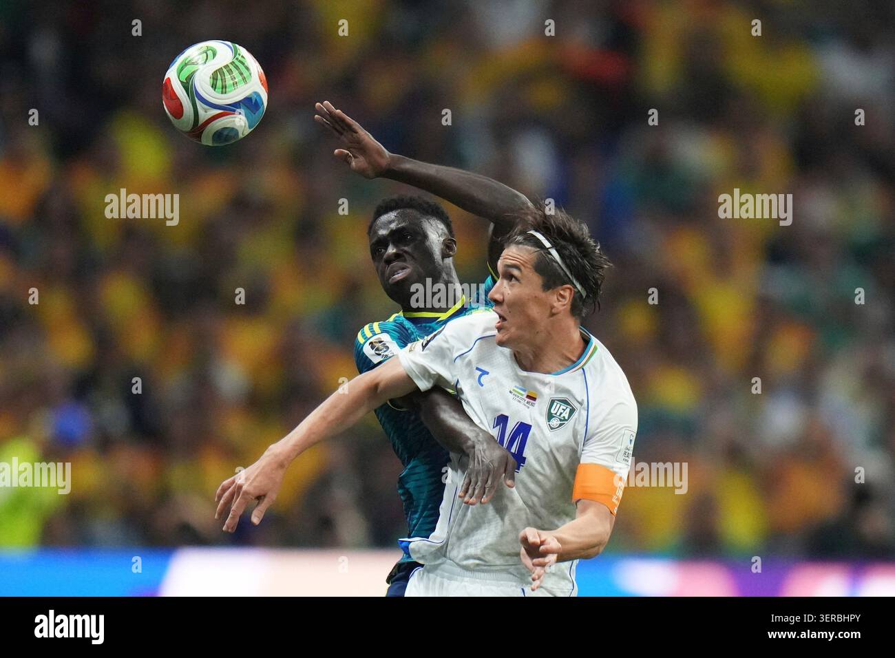 Uzbekistan's Eldor Shomurodov (14) battles for the ball with Colombia's ...