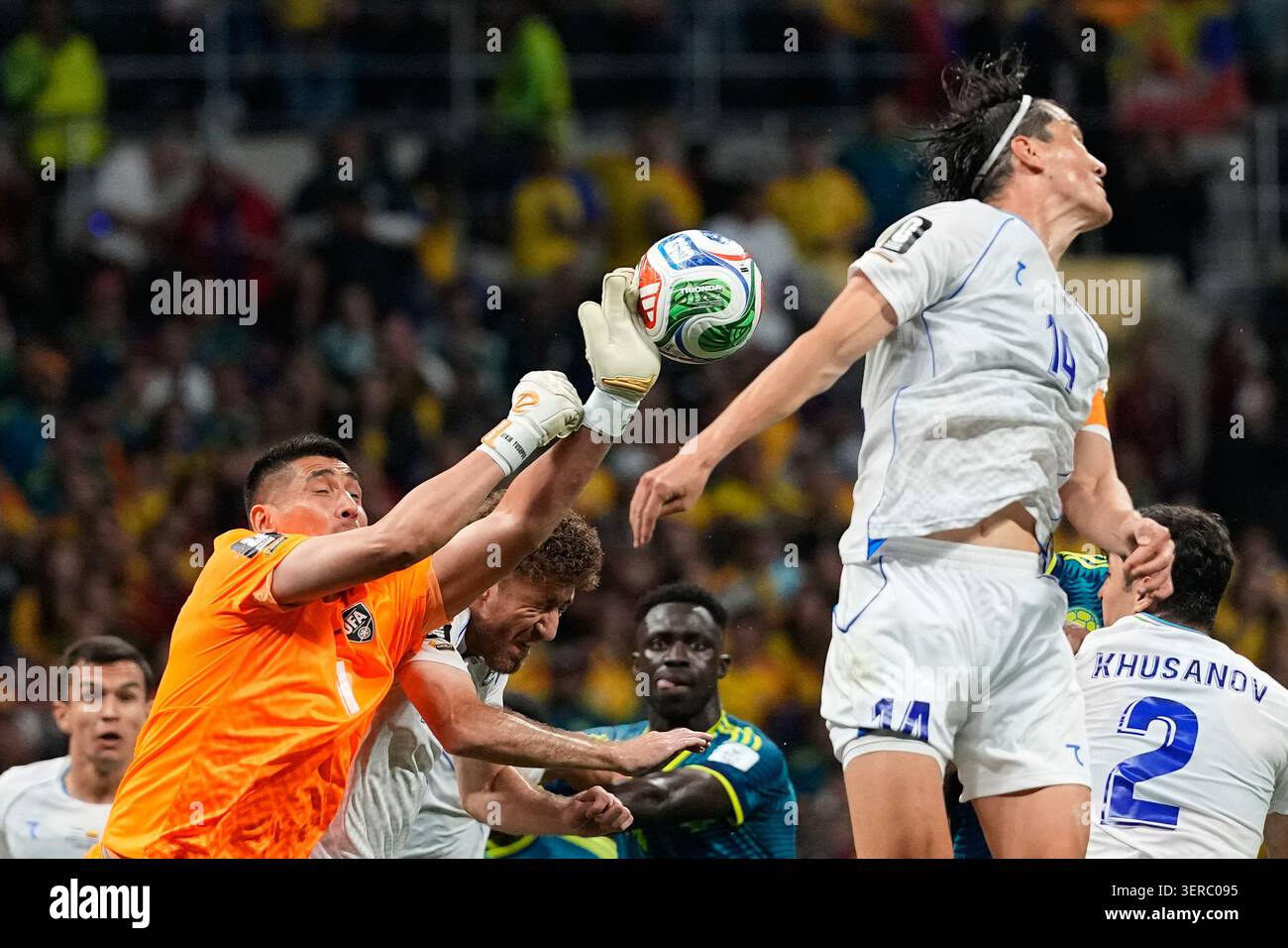 Uzbekistan goalkeeper Utkir Yusupov punches the ball clear of the goal ...