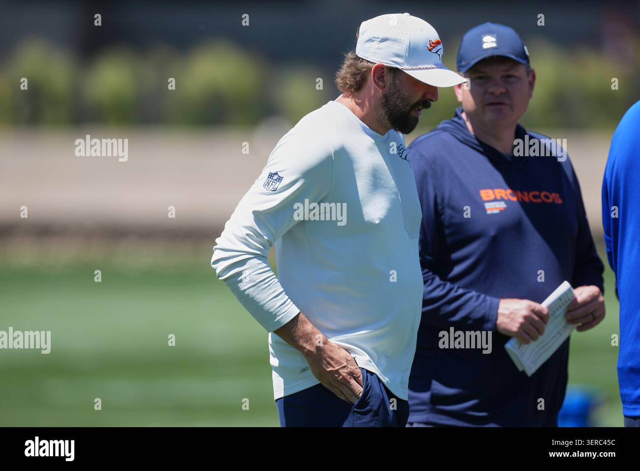 Denver Broncos offensive coordinator Davis Webb looks on as players ...