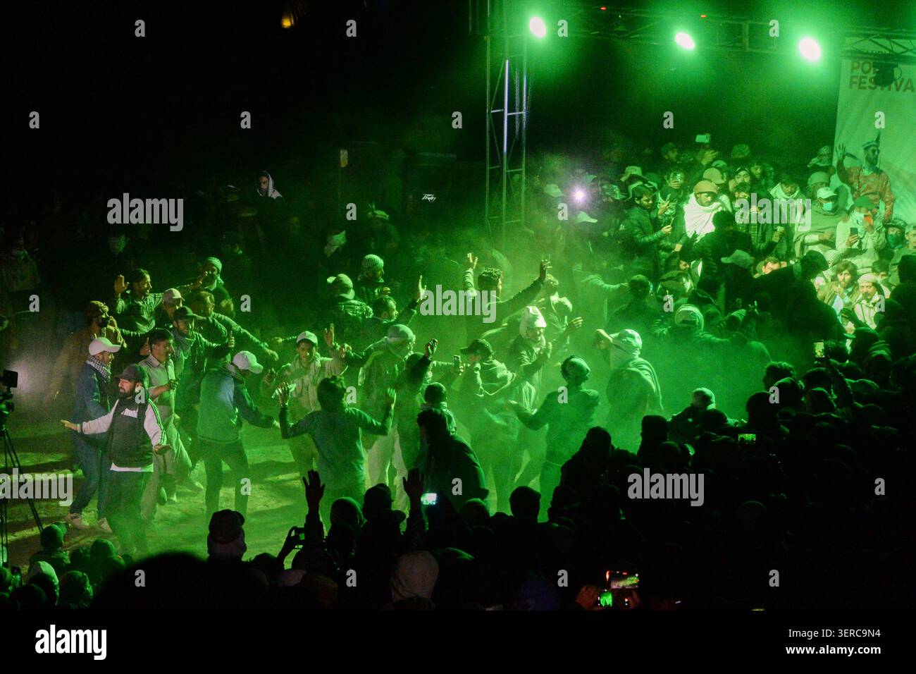 Spectators dance in a temporary settlement made of tents during the ...