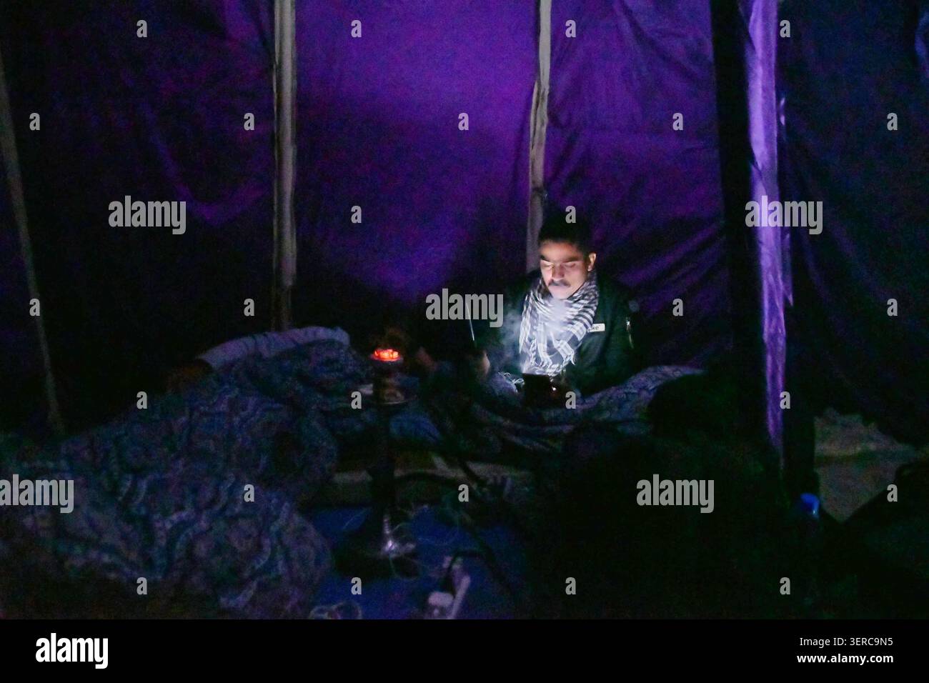 Spectators rest inside their tent in the venue of the three-day annual ...