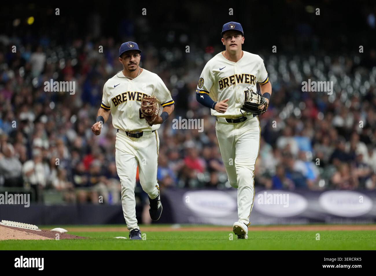 Milwaukee Brewers' Cooper Pratt jogs to the dugout with David Hamilton ...