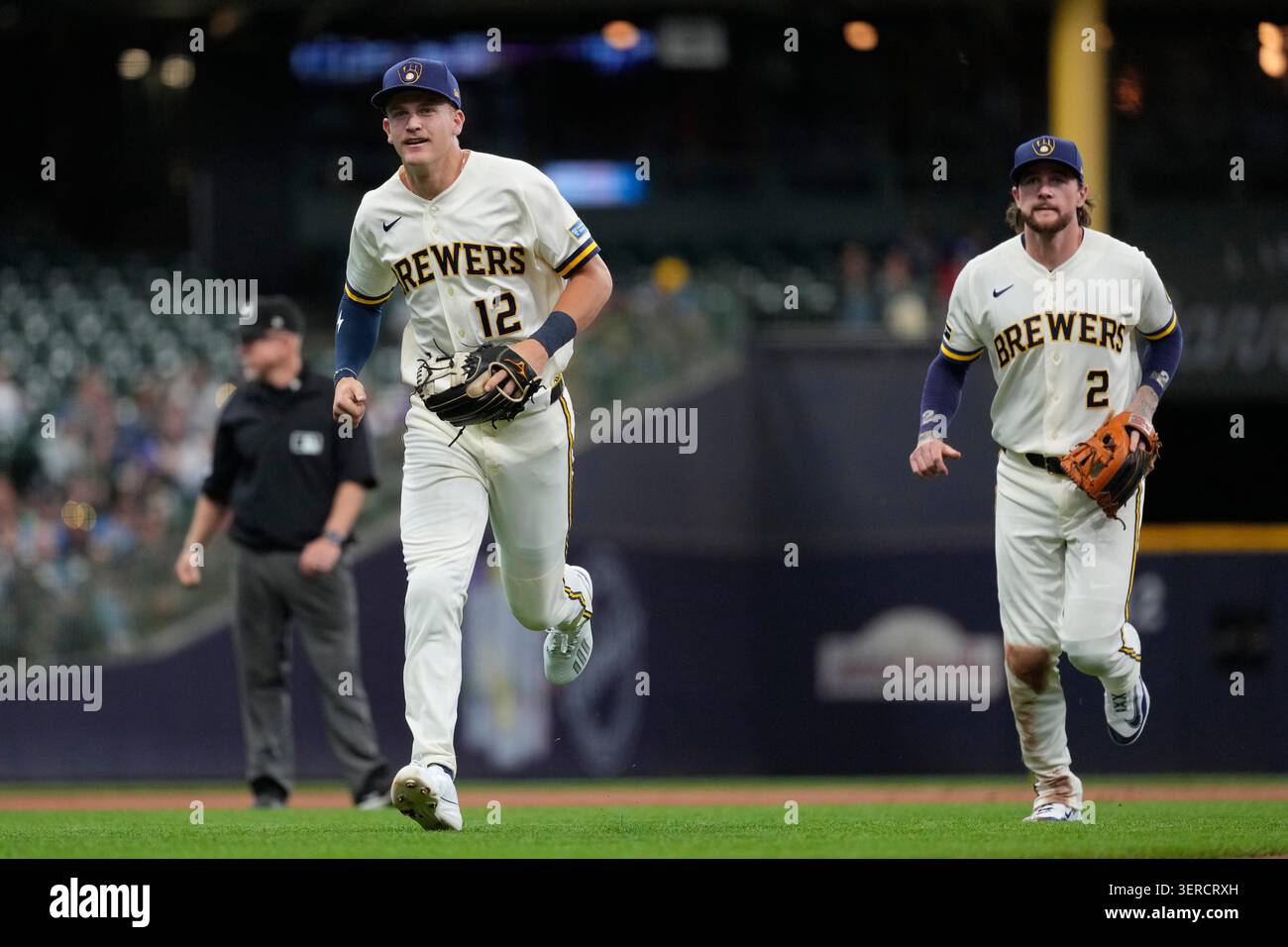 Milwaukee Brewers' Cooper Pratt jogs to the dugout with Brice Turang ...