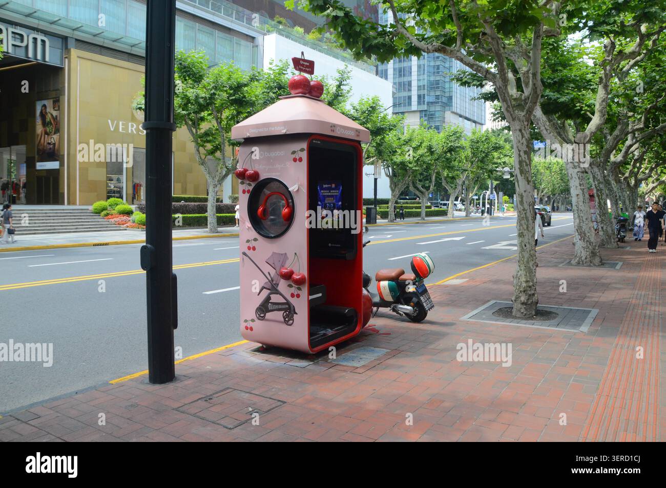 A self-service phone booth decorated with cherry ornaments adds a touch ...