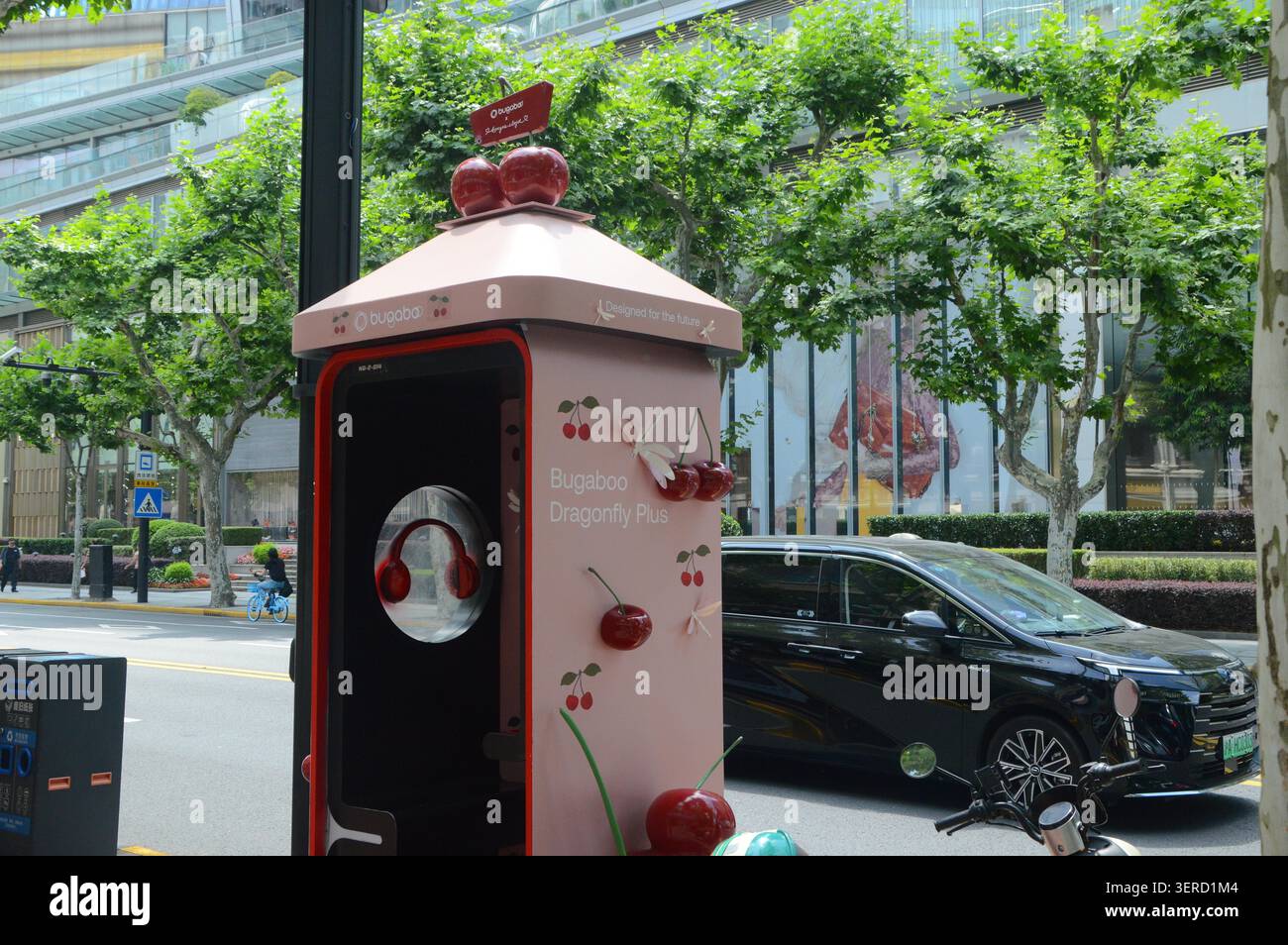 A self-service phone booth decorated with cherry ornaments adds a touch ...