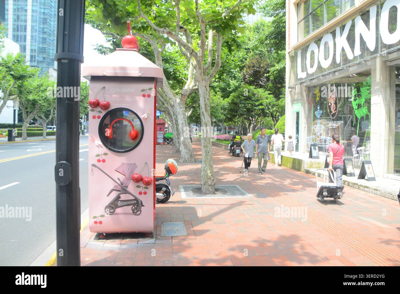 A self-service phone booth decorated with cherry ornaments adds a touch ...