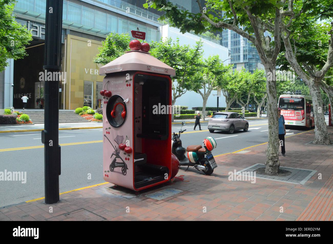 A self-service phone booth decorated with cherry ornaments adds a touch ...