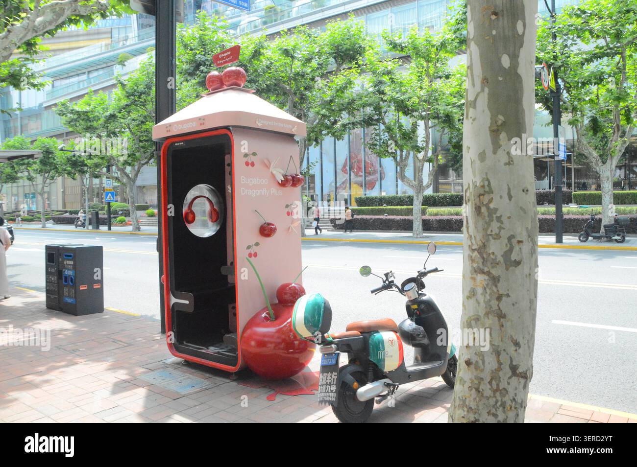 A self-service phone booth decorated with cherry ornaments adds a touch ...