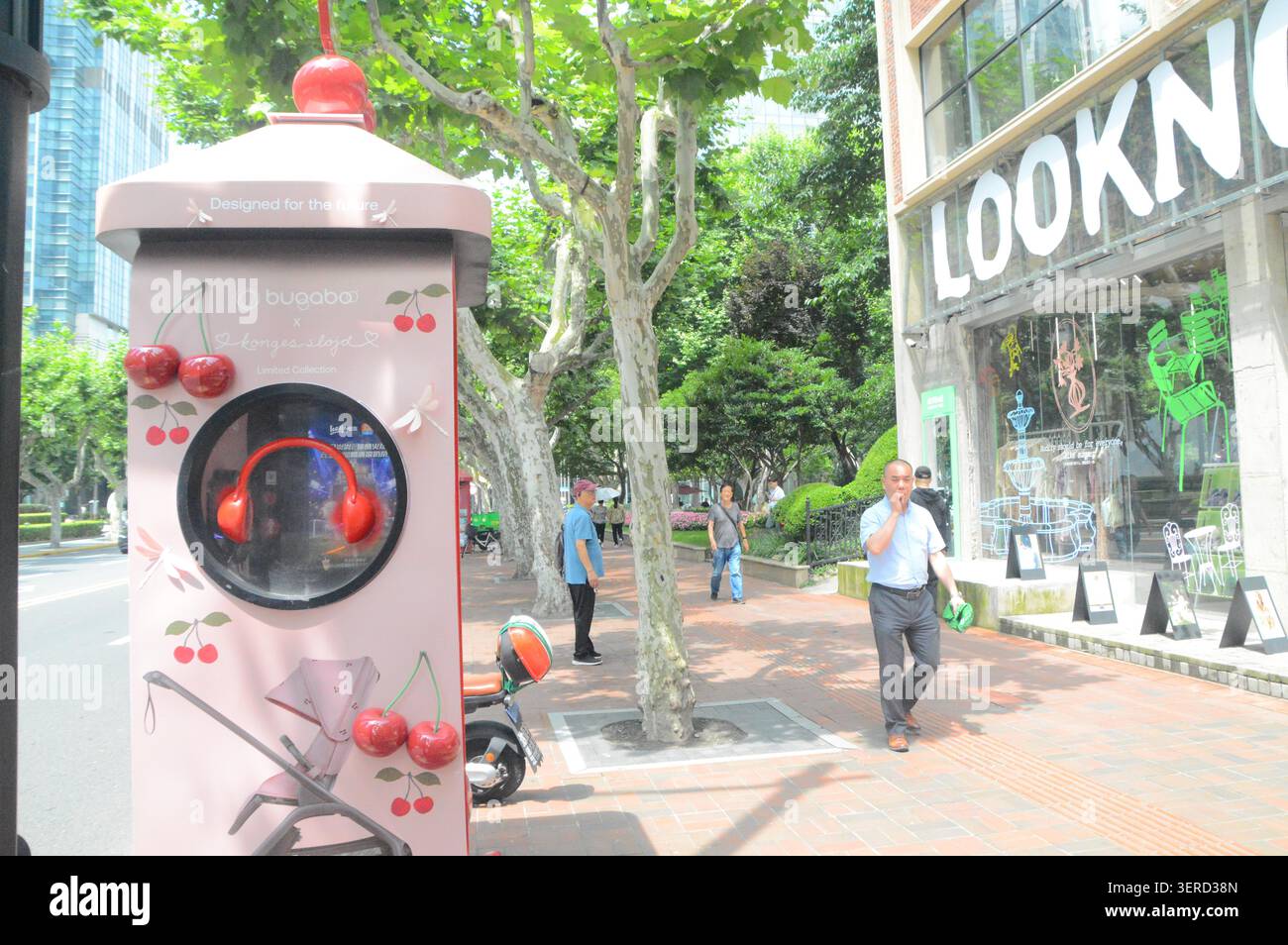 A self-service phone booth decorated with cherry ornaments adds a touch ...