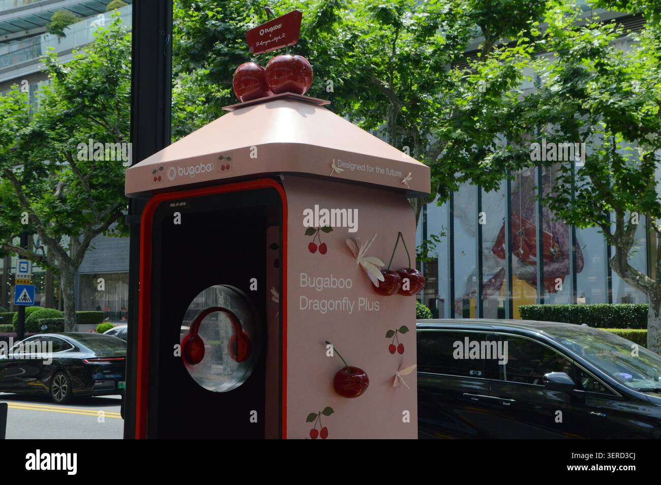 A self-service phone booth decorated with cherry ornaments adds a touch ...