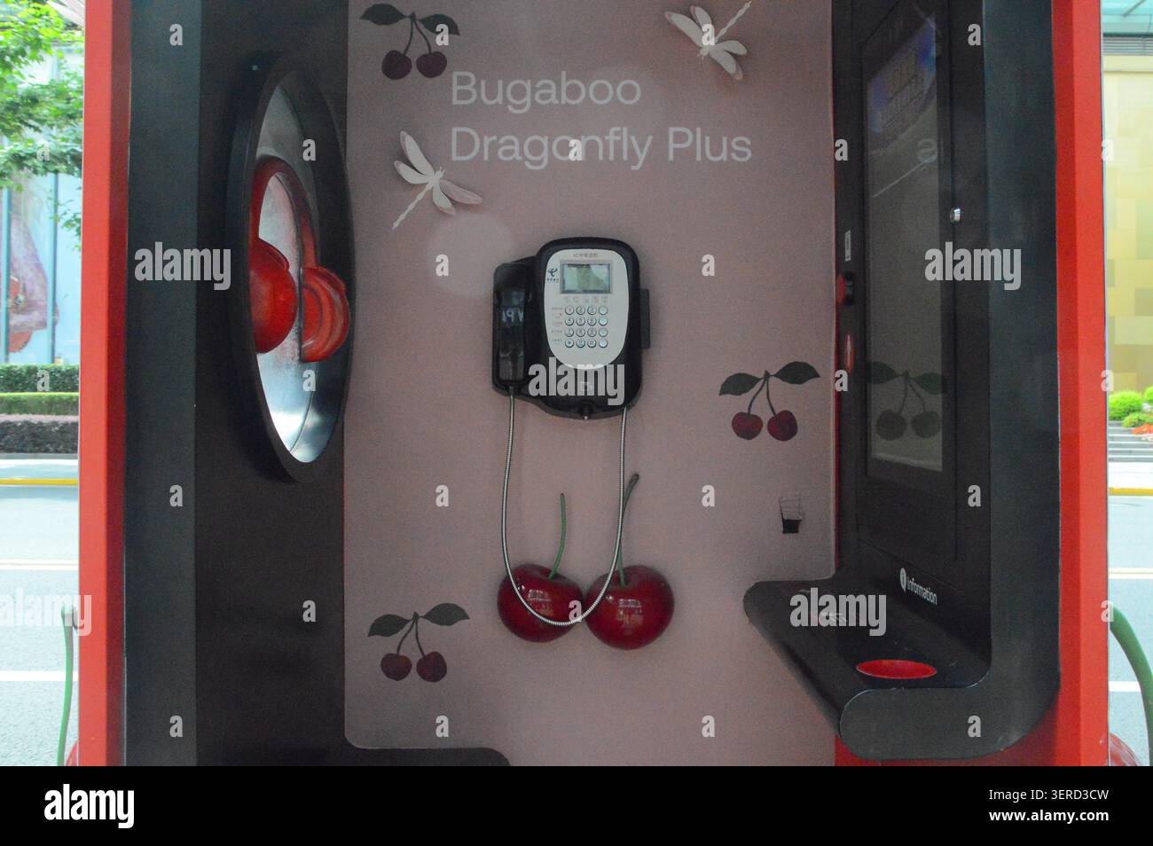 A self-service phone booth decorated with cherry ornaments adds a touch ...