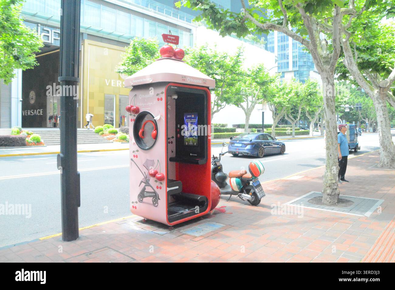 A self-service phone booth decorated with cherry ornaments adds a touch ...