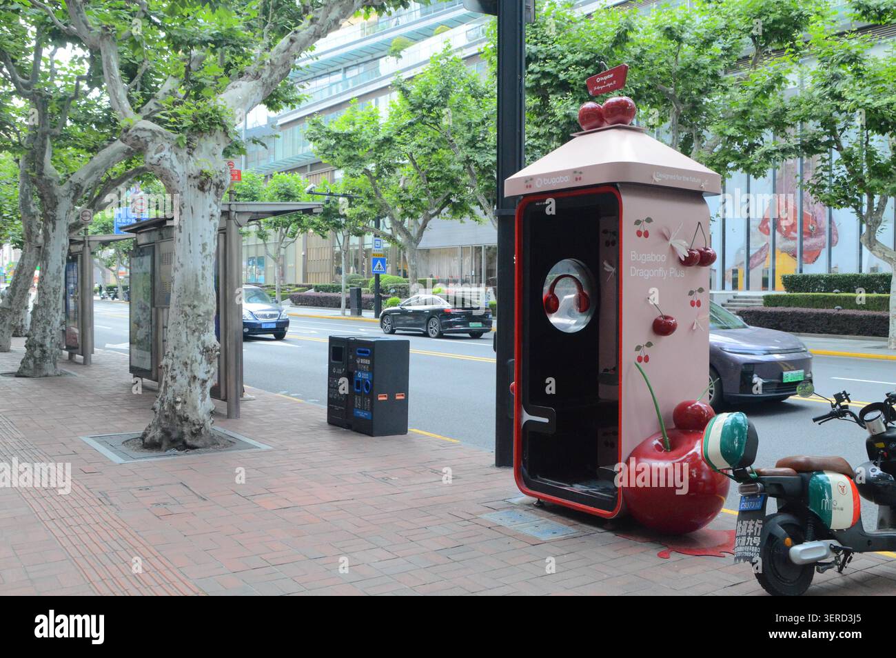 A self-service phone booth decorated with cherry ornaments adds a touch ...