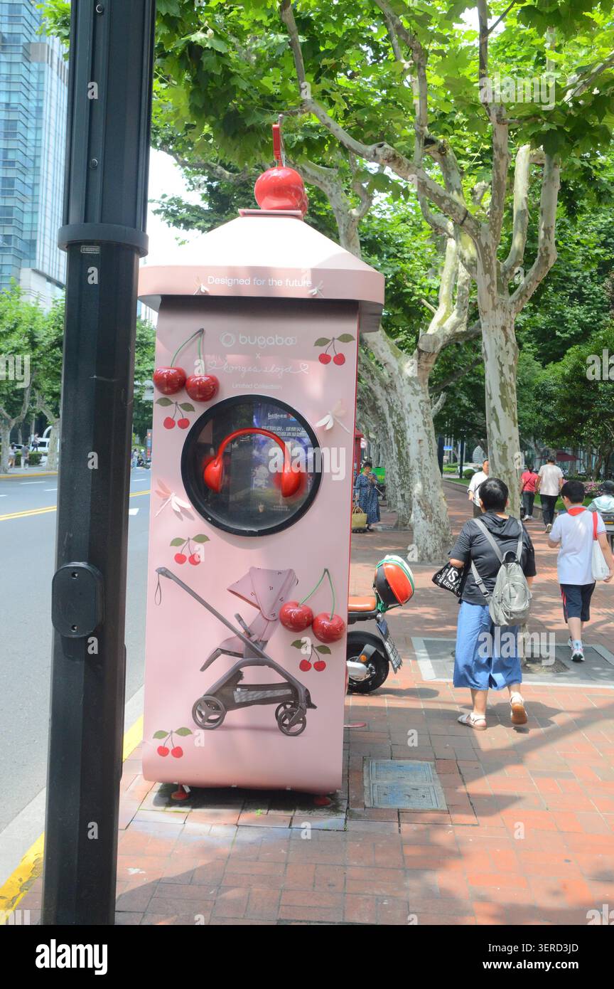 A self-service phone booth decorated with cherry ornaments adds a touch ...