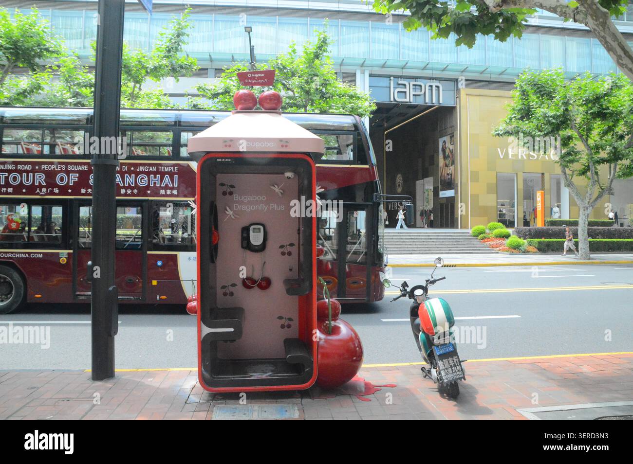 A self-service phone booth decorated with cherry ornaments adds a touch ...