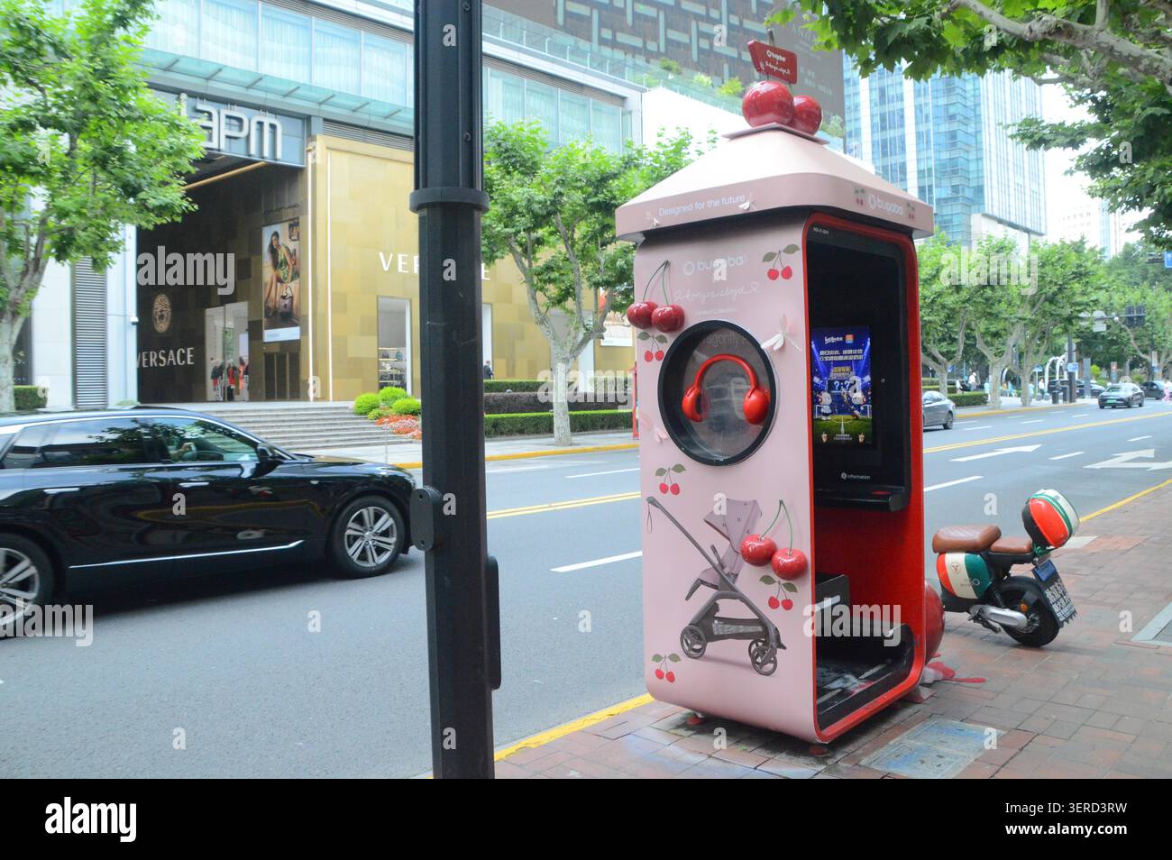 A self-service phone booth decorated with cherry ornaments adds a touch ...