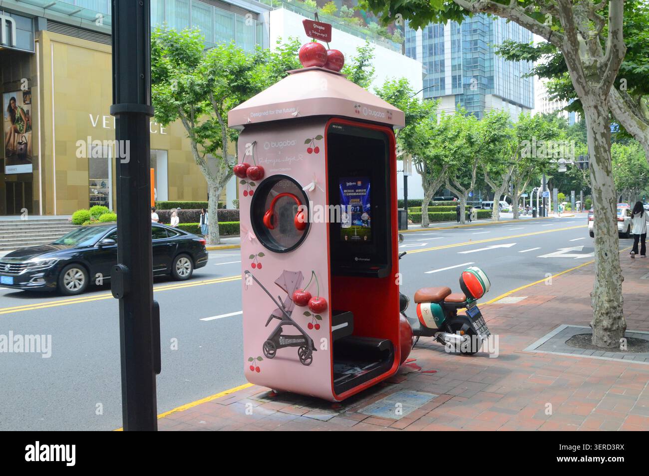 A self-service phone booth decorated with cherry ornaments adds a touch ...
