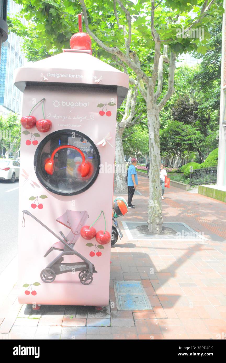 A self-service phone booth decorated with cherry ornaments adds a touch ...