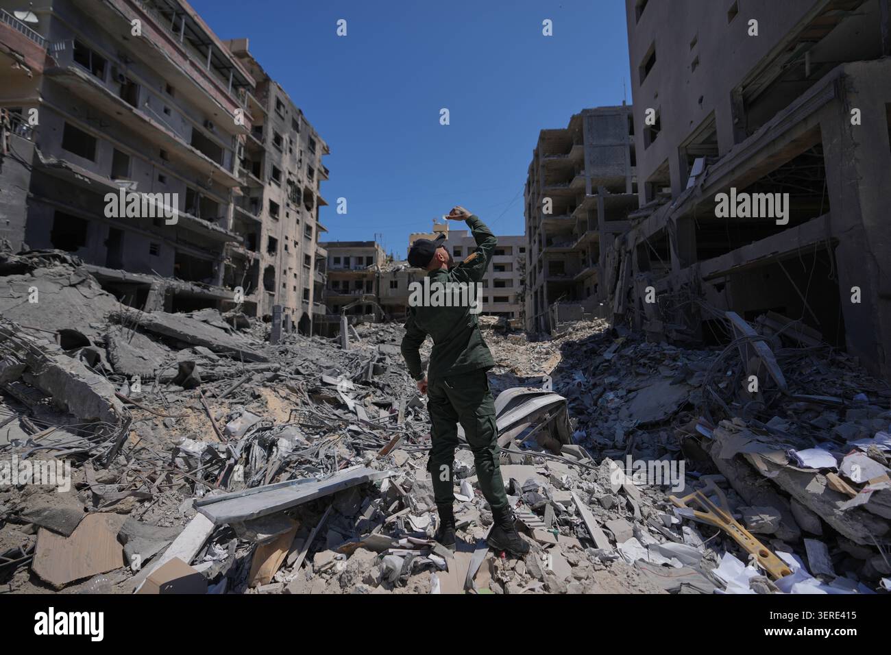 A municipal police officer inspects buildings damaged in Israeli ...