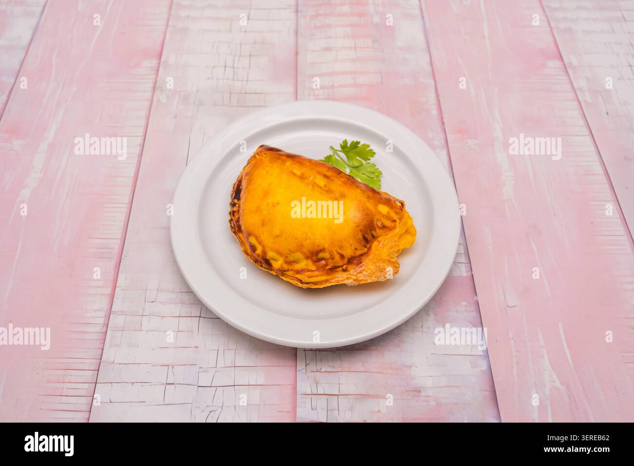 A tray full of fried empanadas, round and semicircular, with dough of ...