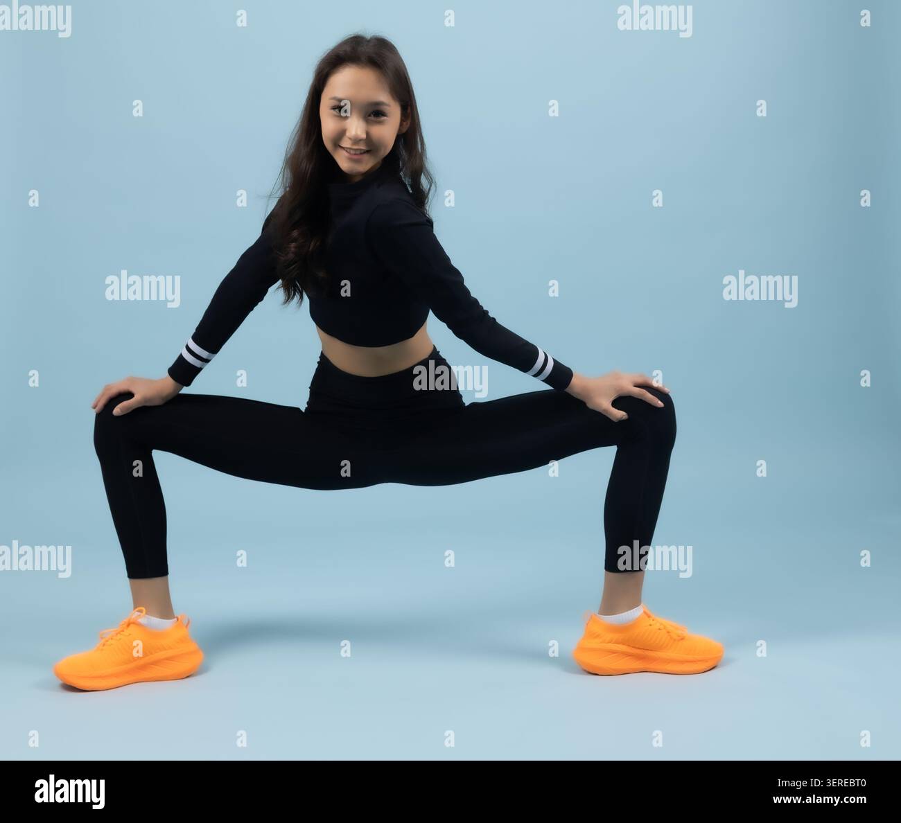Woman doing a deep wide squat pose Stock Photo - Alamy