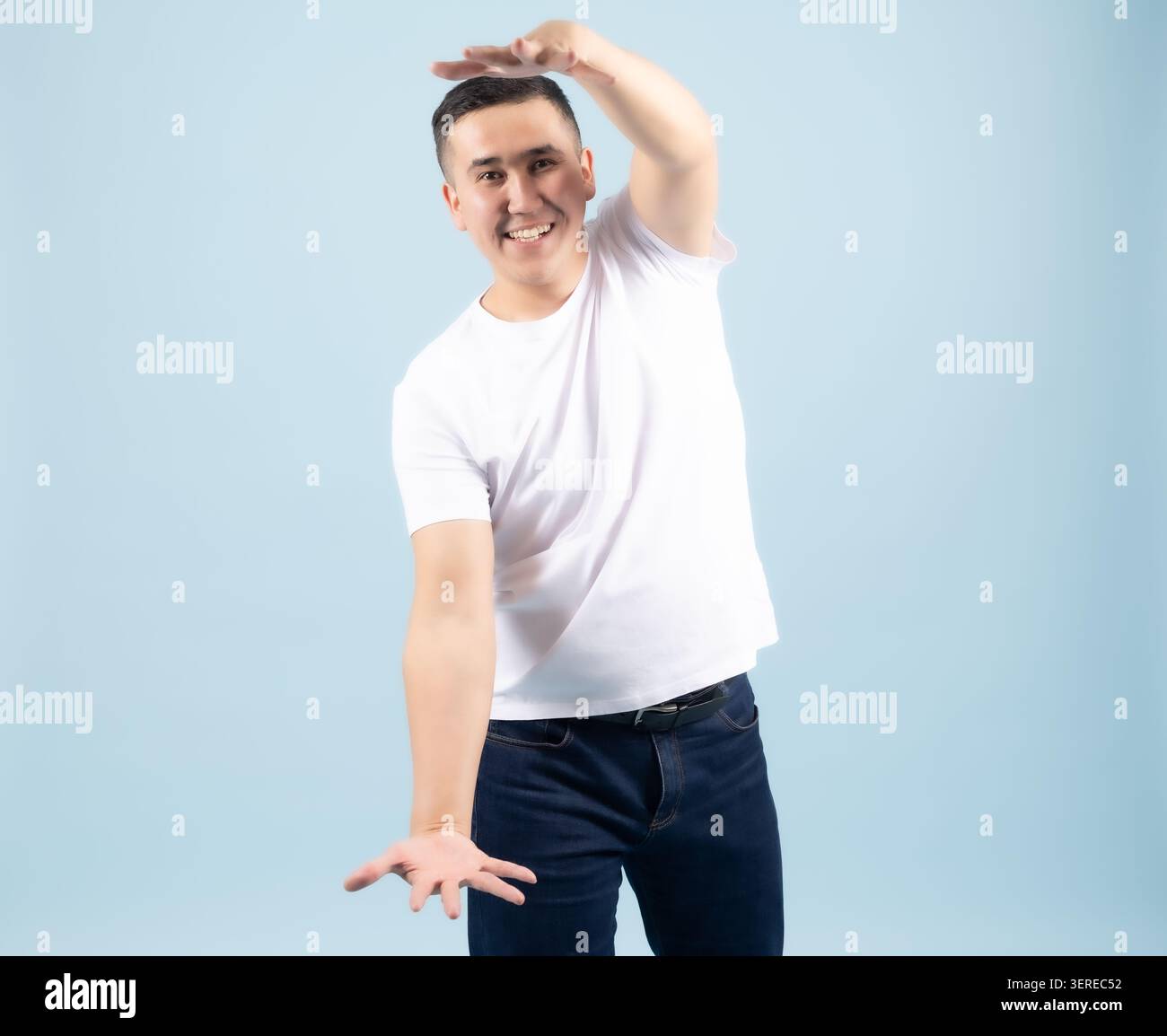 Man posing with arms curved above his head Stock Photo - Alamy
