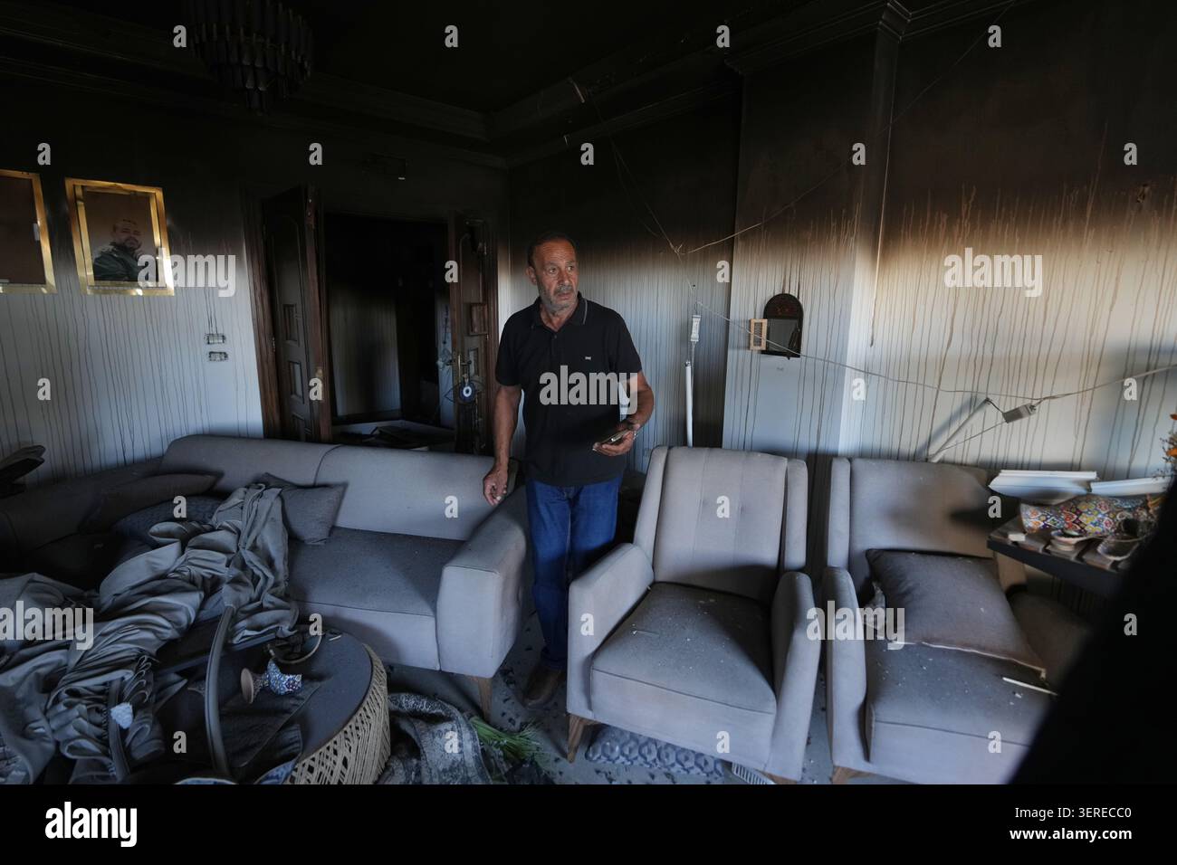 Resident Samih Haidar inspects his burned apartment damaged in Israeli ...
