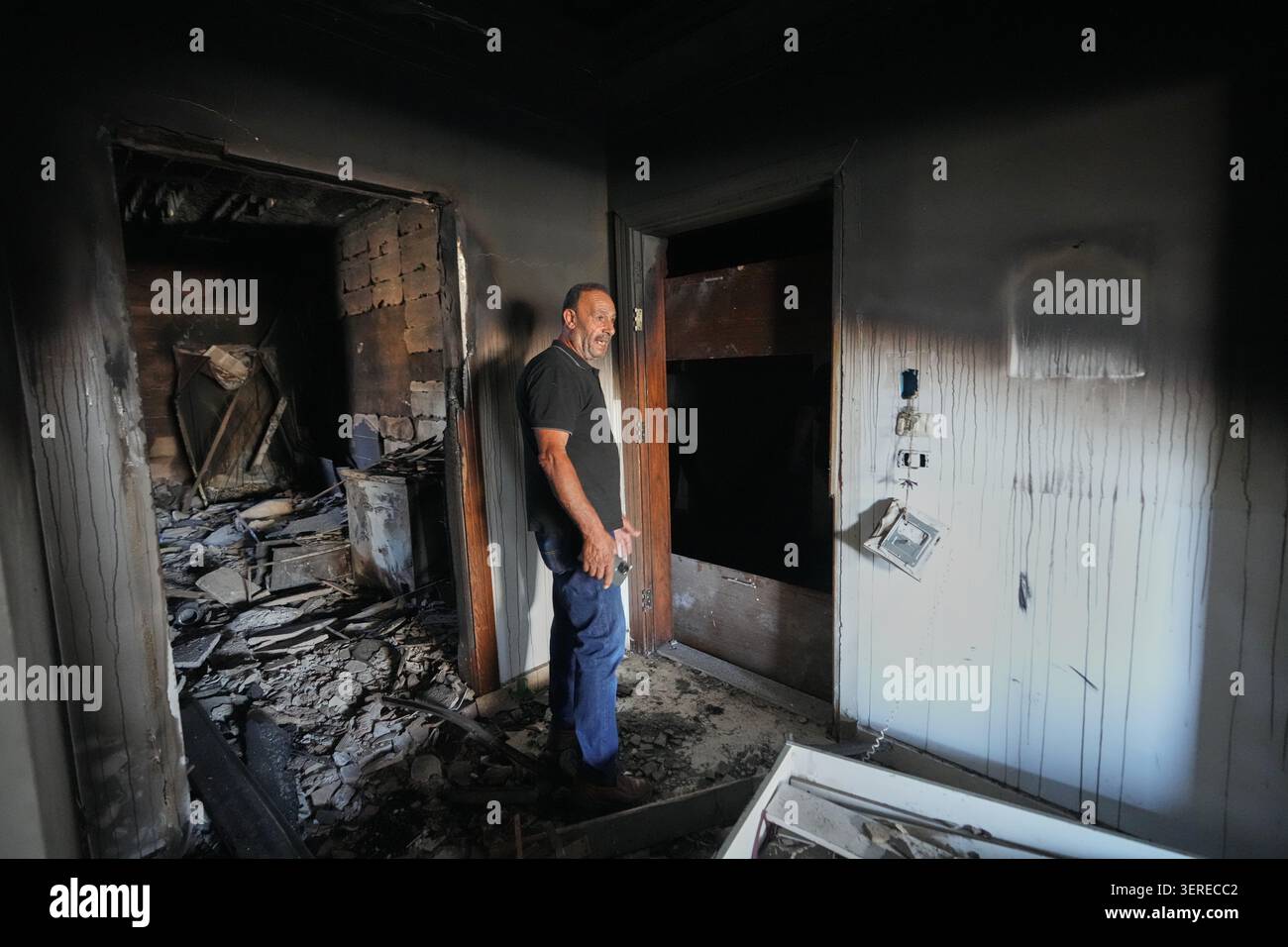 Resident Samih Haidar reacts as he inspects his burned apartment ...
