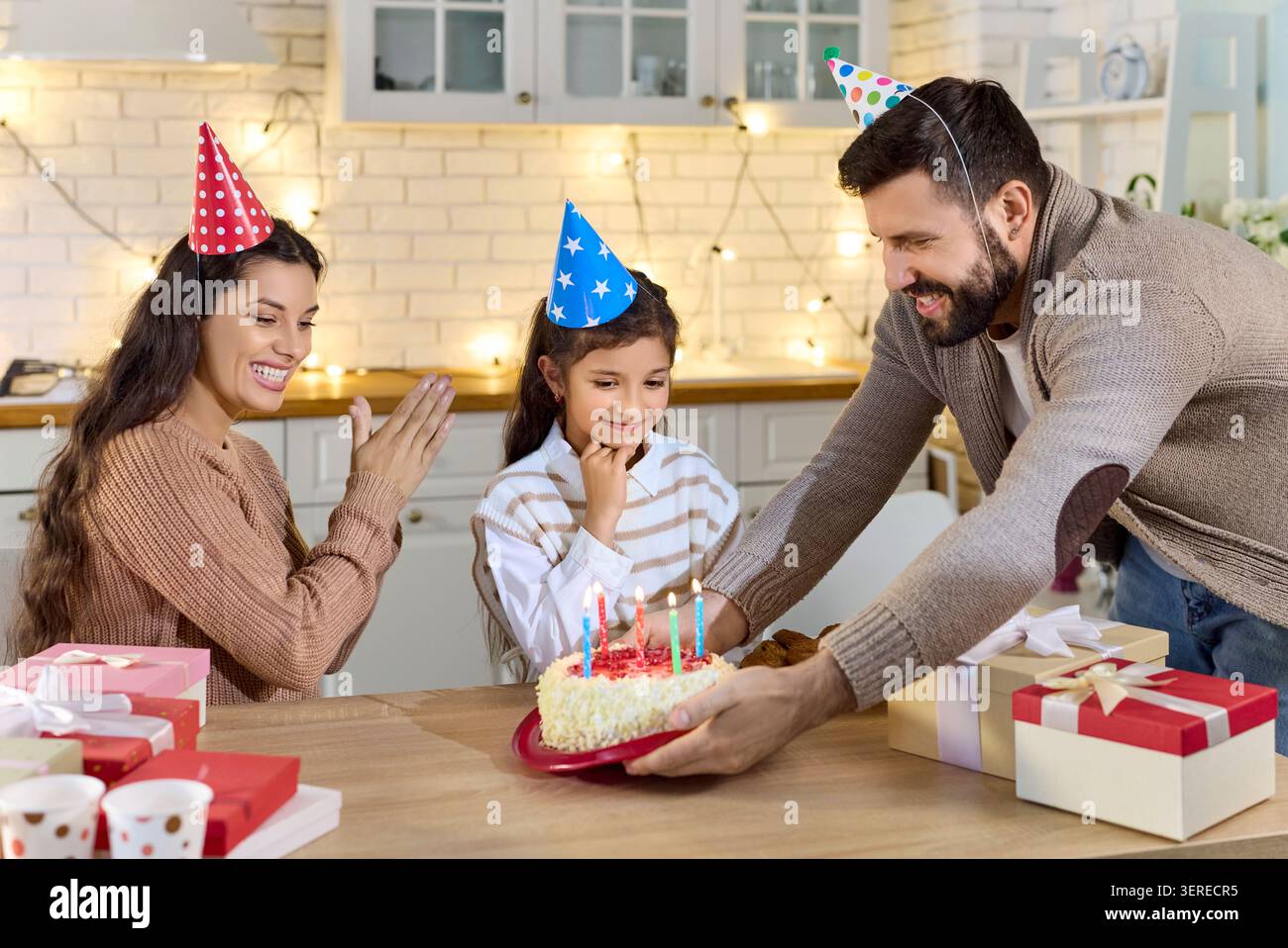 Family birthday party with parents and child, father giving cake with ...