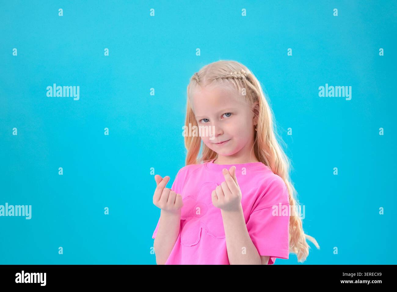 A young girl makes a heart gesture with her fingers Stock Photo - Alamy