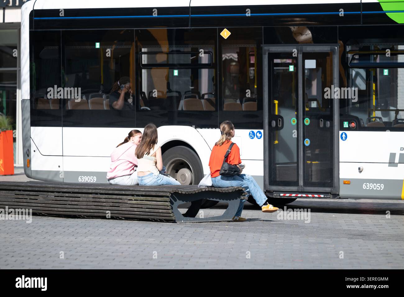 Teenage girls waiting for a De Lijn school bus in Geel... Geel, Belgium ...