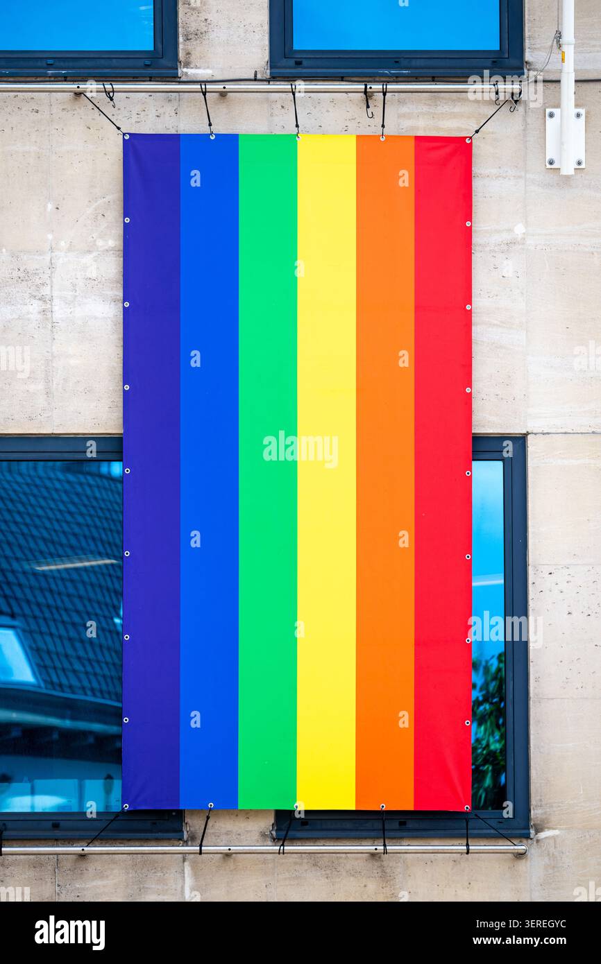 An LGBTQ+ rainbow flag hangs from a building facade in central Brussels ...