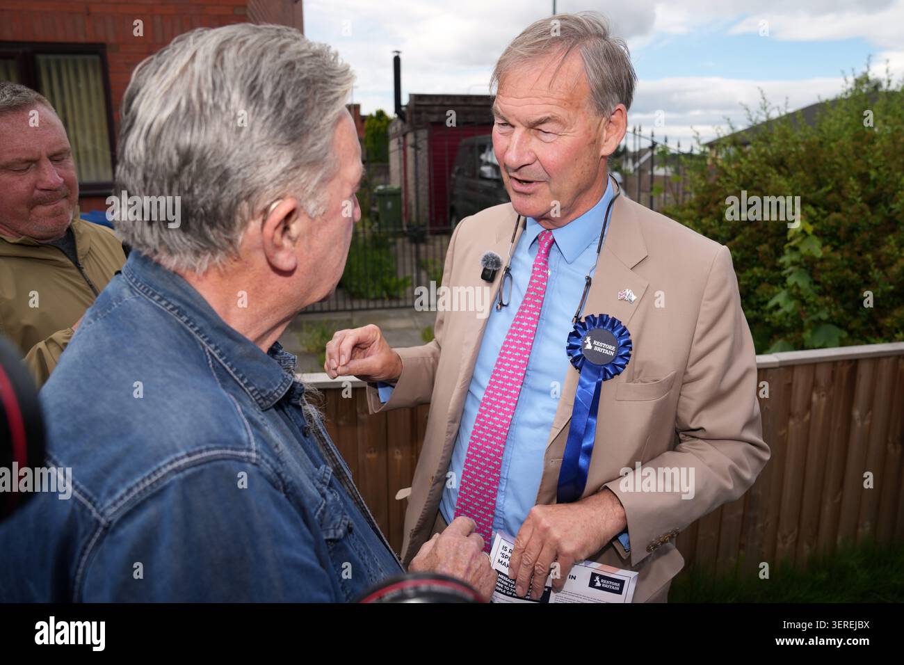 Britain's leader of Restore Britain Rupert Lowe speaks to a member of ...