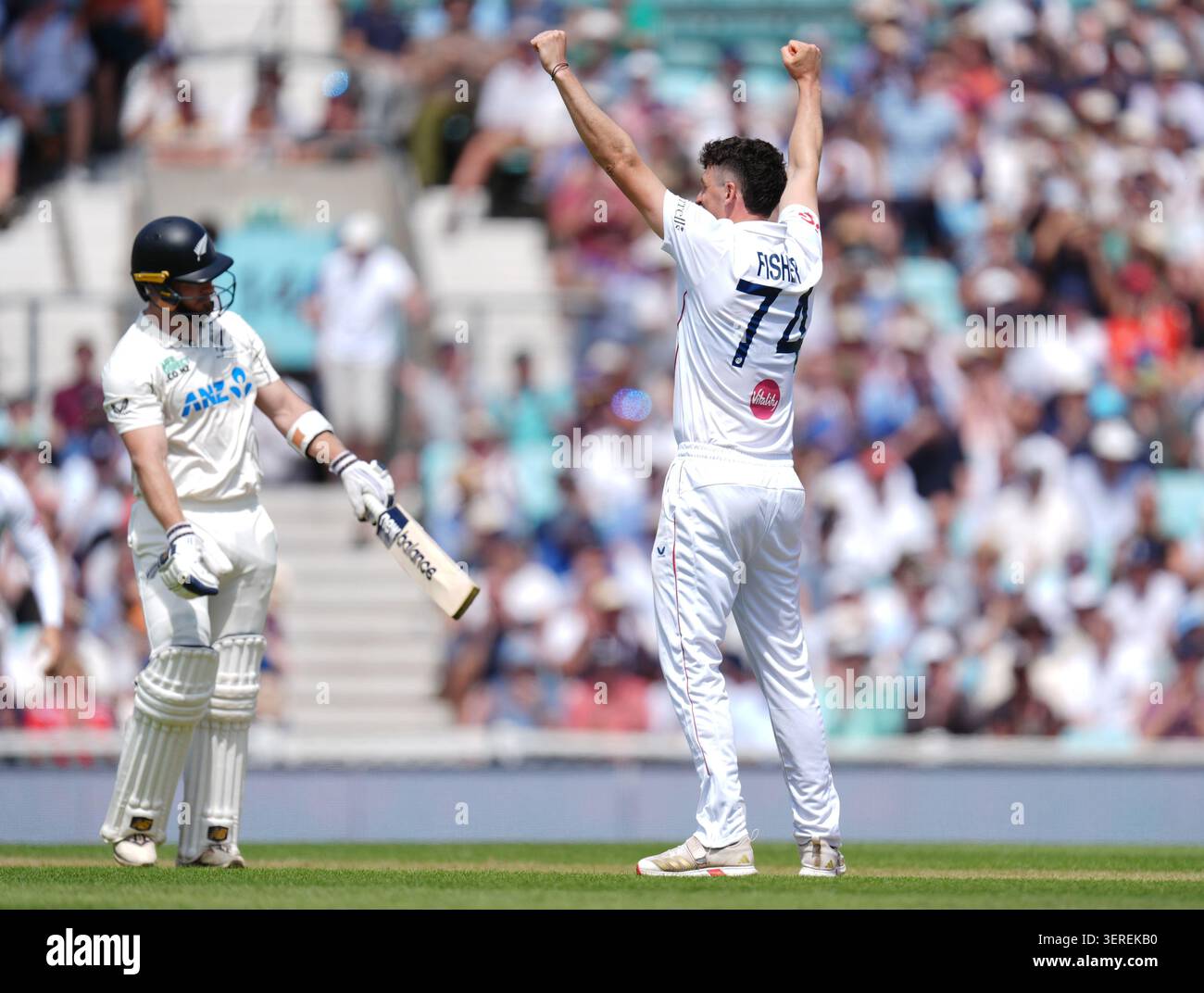 England's Matt Fisher celebrates taking the wicket of New Zealand's ...
