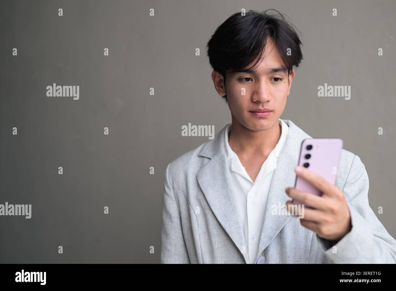 Horizontal medium shot of a young nonbinary gender fluid Thai Isan ...