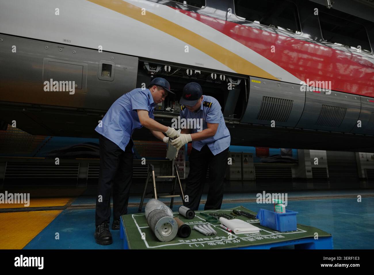 Railway workers demonstrate a service to a high-speed electric multiple ...